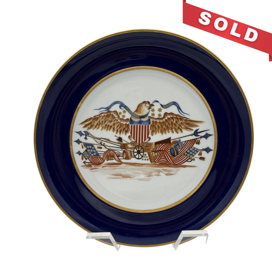Plate with eagle with shield and banner – The History List